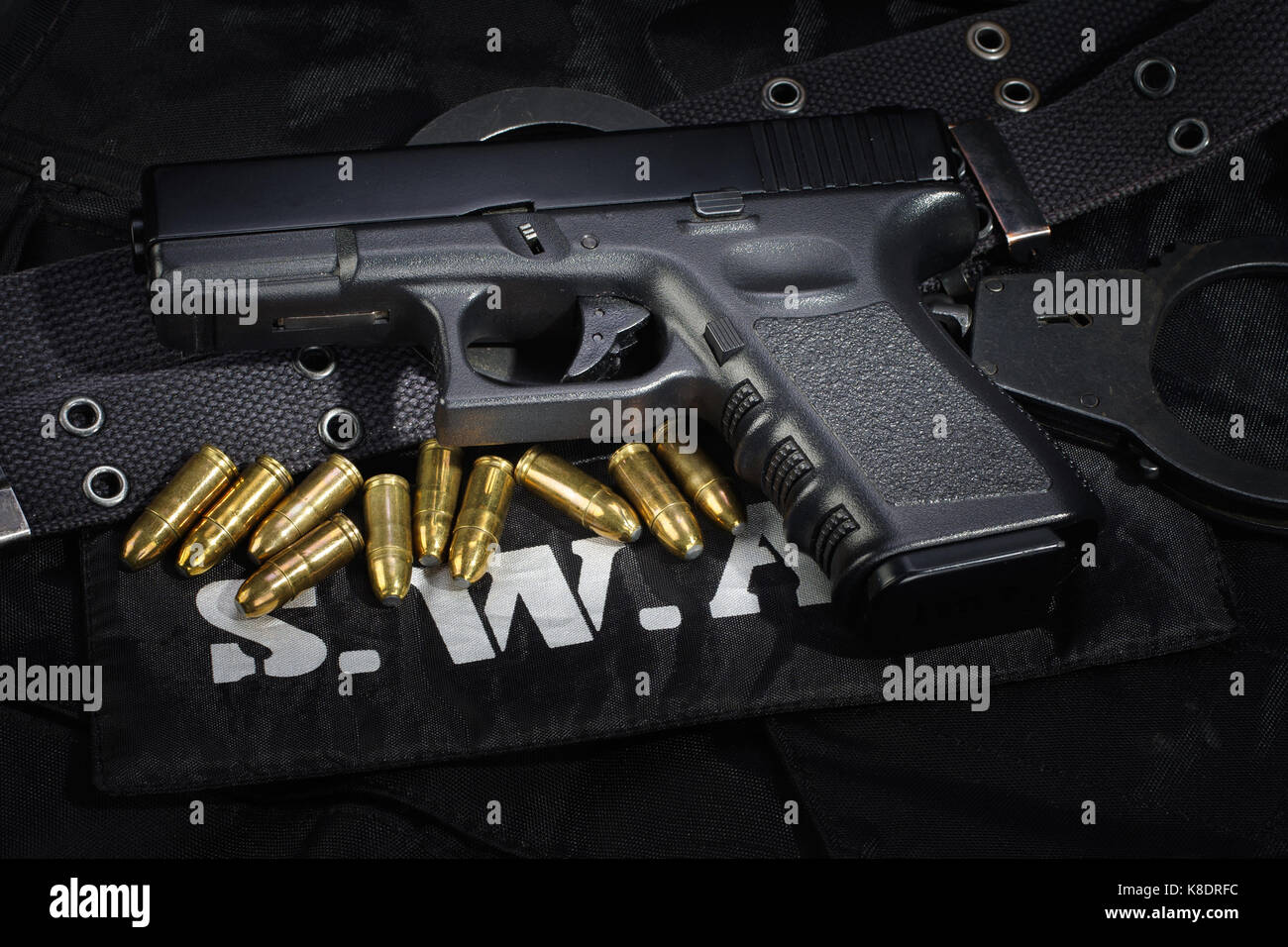 SWAT weapon and equipment on black uniform background Stock Photo - Alamy
