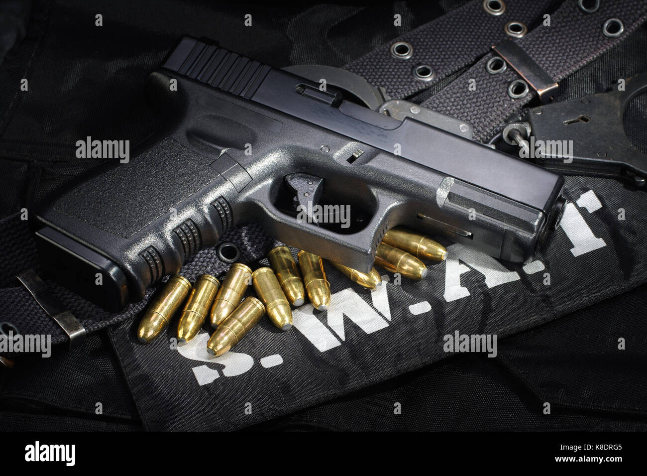 SWAT weapon and equipment on black uniform background Stock Photo - Alamy