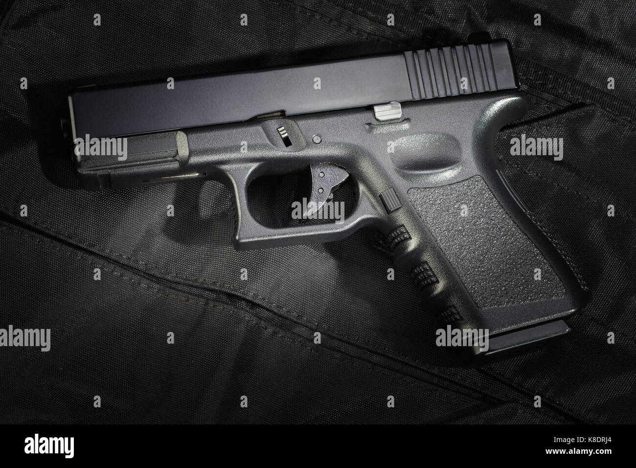 Police weapon and equipment on black uniform background Stock Photo - Alamy