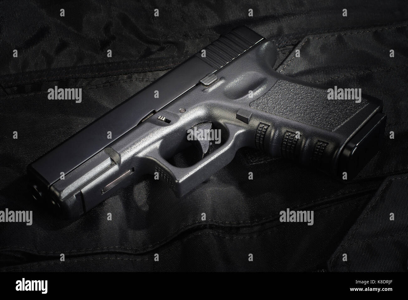 Police weapon and equipment on black uniform background Stock Photo - Alamy
