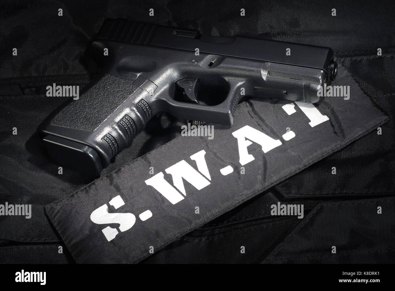 SWAT weapon and equipment on black uniform background Stock Photo - Alamy