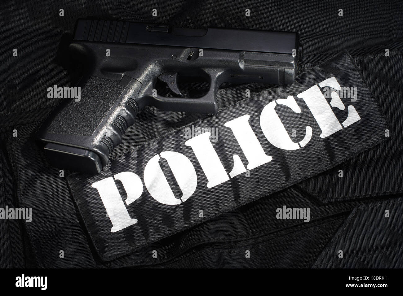 Police weapon and equipment on black uniform background Stock Photo - Alamy