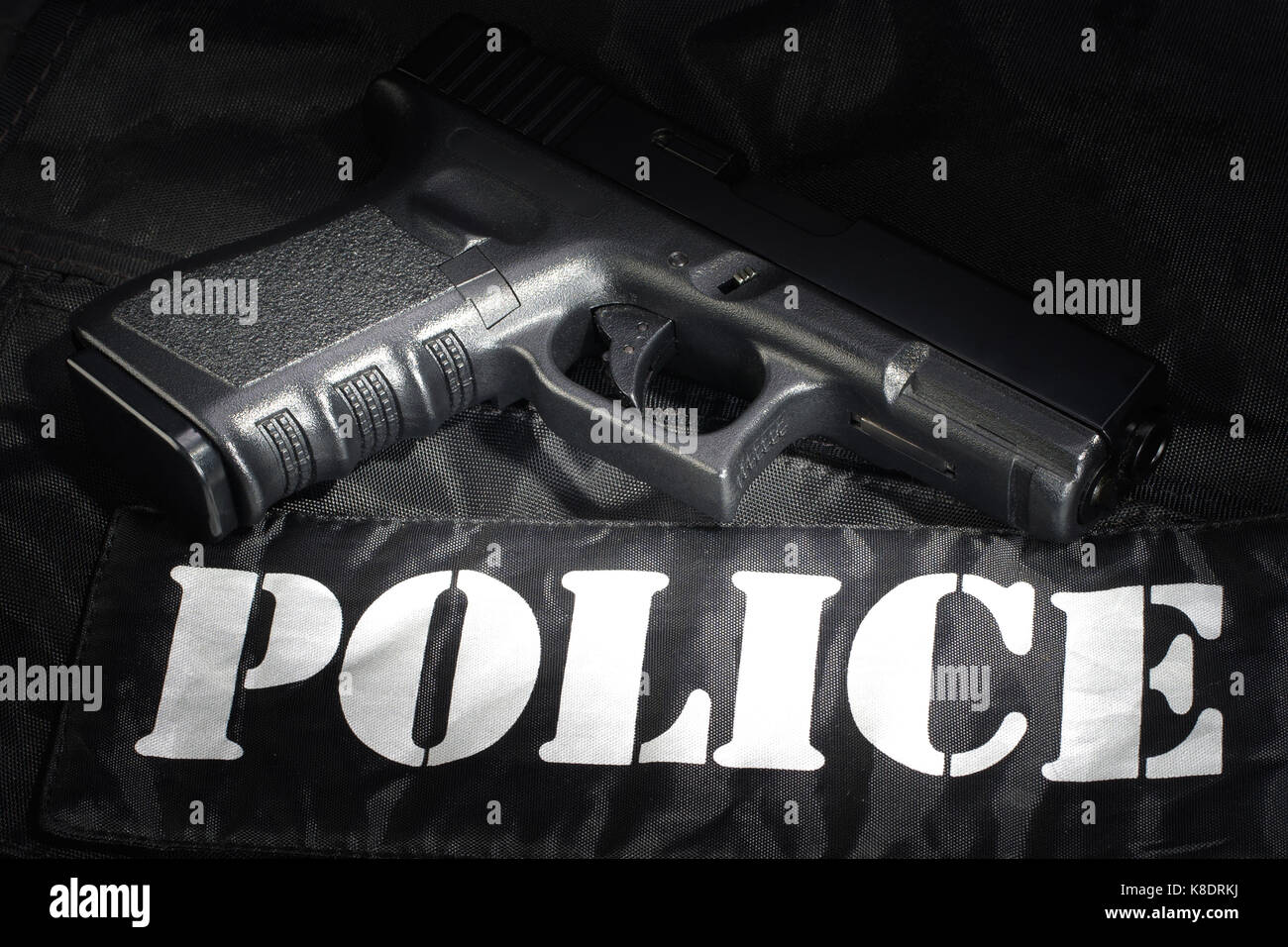 Police weapon and equipment on black uniform background Stock Photo - Alamy