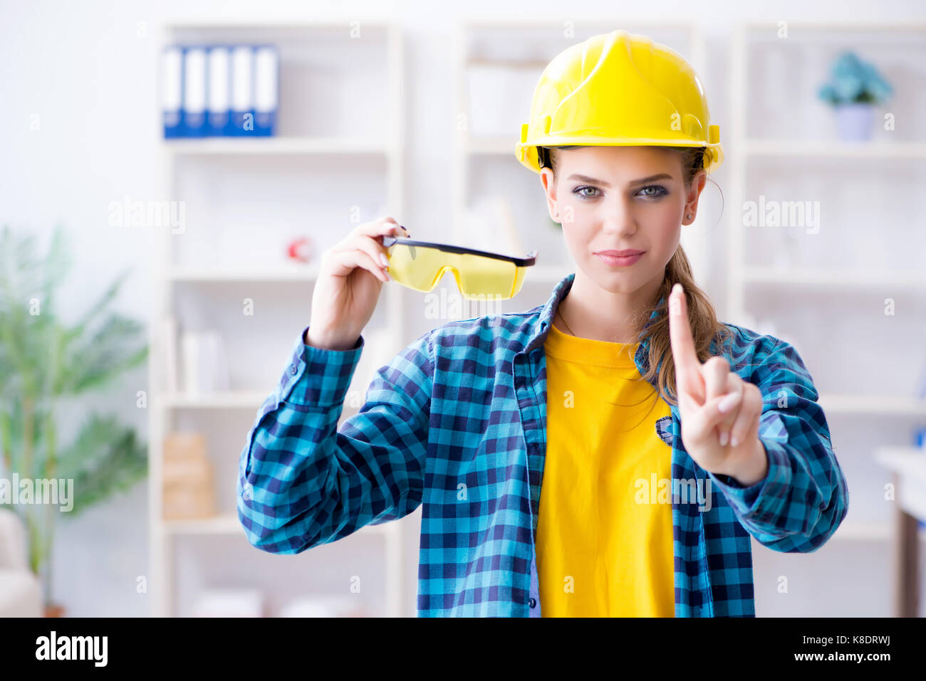 Woman in workshop with protective goggles Stock Photo - Alamy