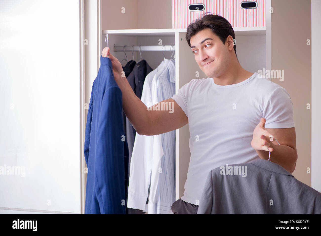 Young man businessman getting dressed for work Stock Photo - Alamy