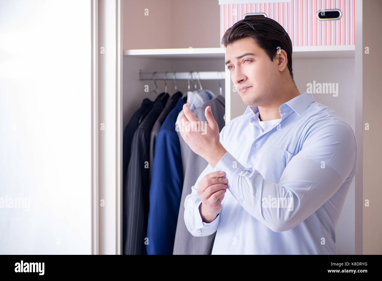 Young man businessman getting dressed for work Stock Photo - Alamy