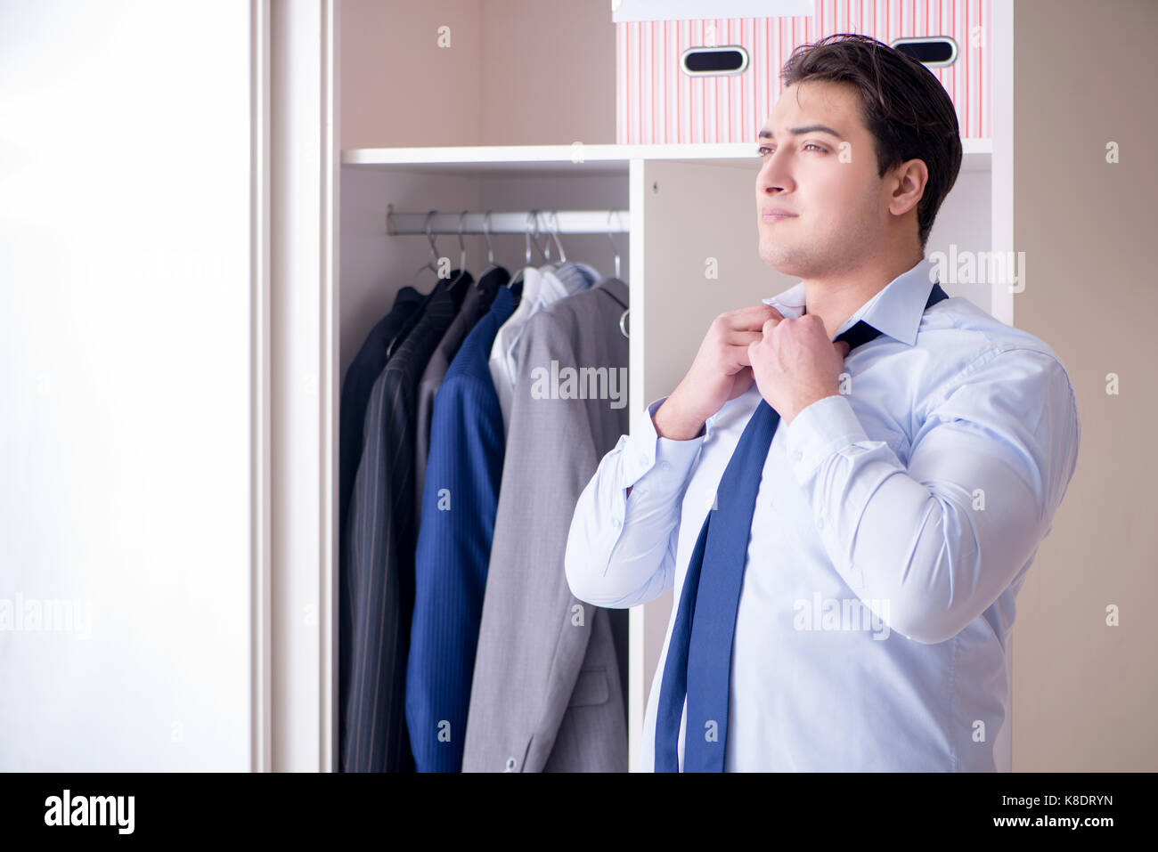 Young man businessman getting dressed for work Stock Photo - Alamy
