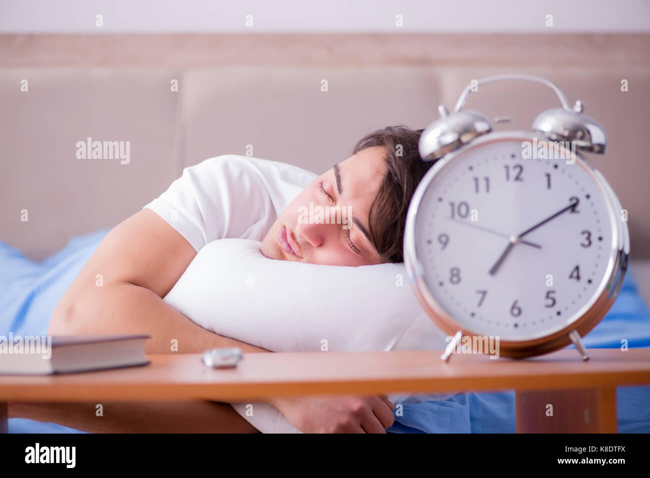 Man in bed frustrated suffering from insomnia with an alarm clock Stock ...