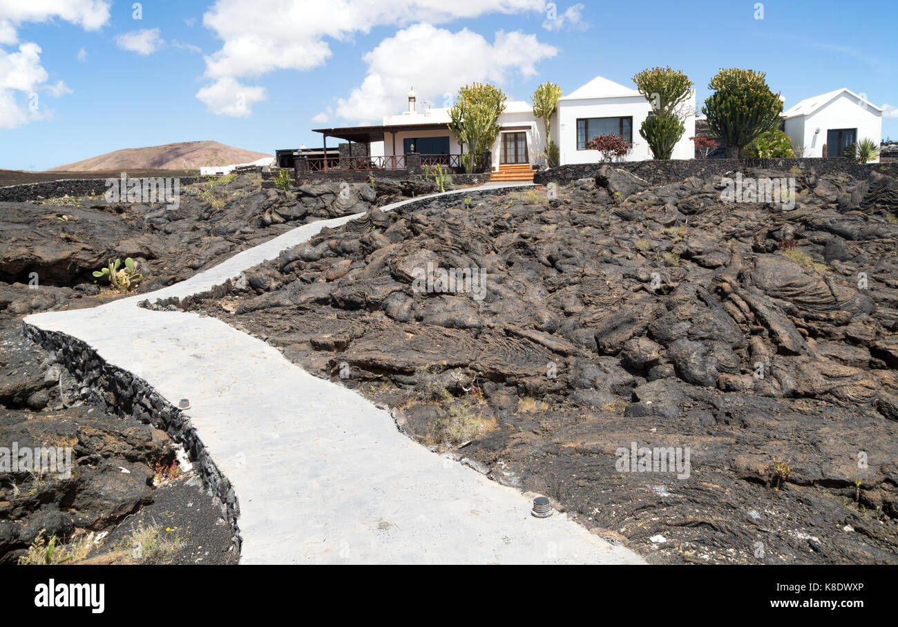 House standing in solidified pahoehoe or ropey lava field, Tahiche ...