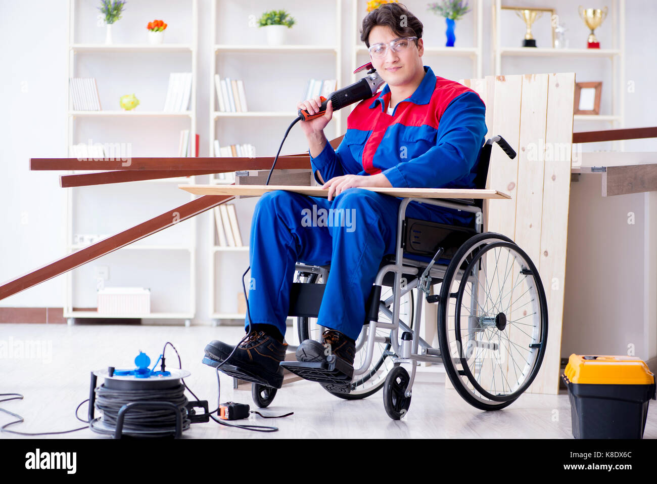 Disabled carpenter working with tools in workshop Stock Photo - Alamy