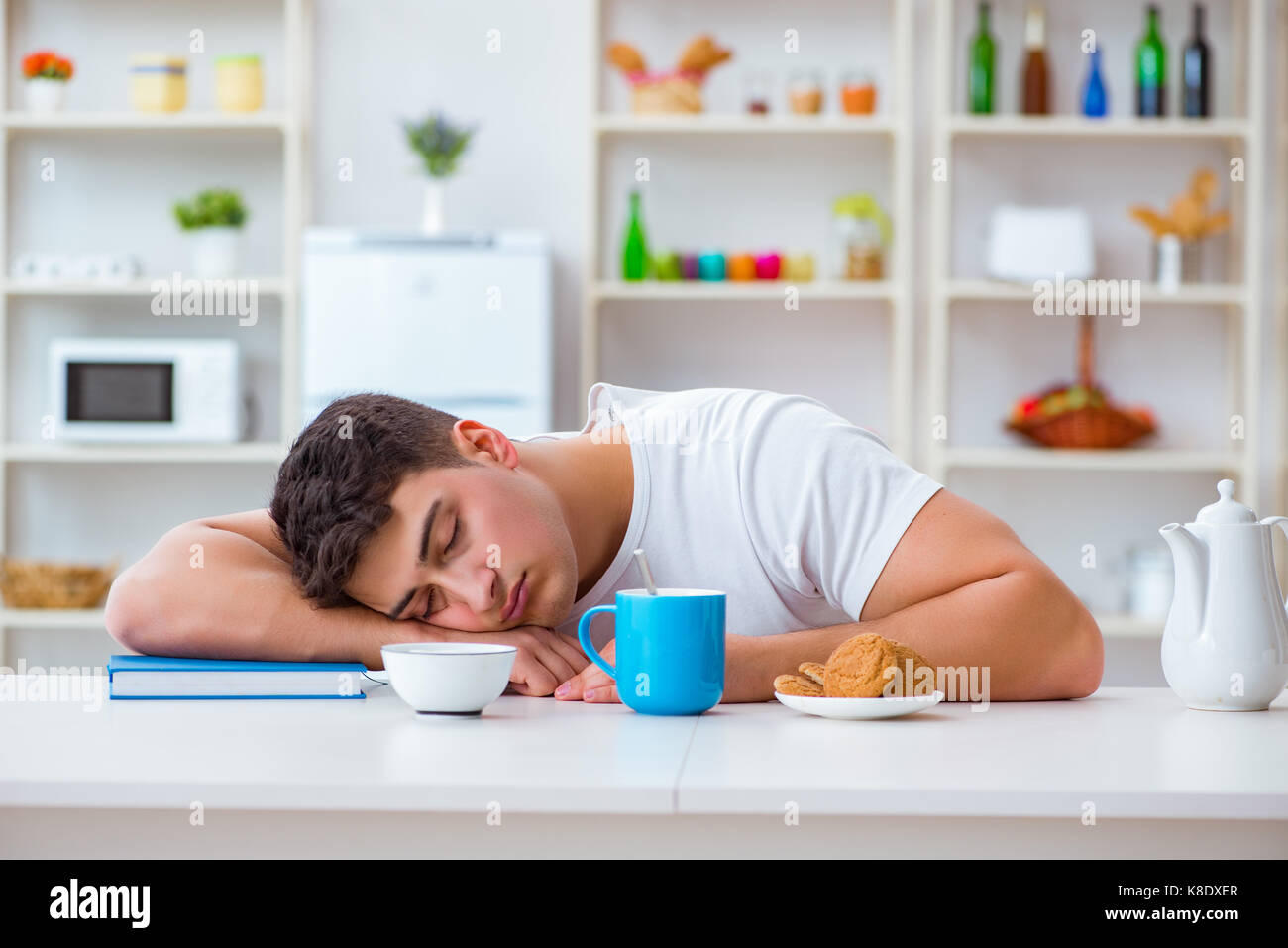 Man falling asleep during his breakfast after overtime work Stock Photo ...