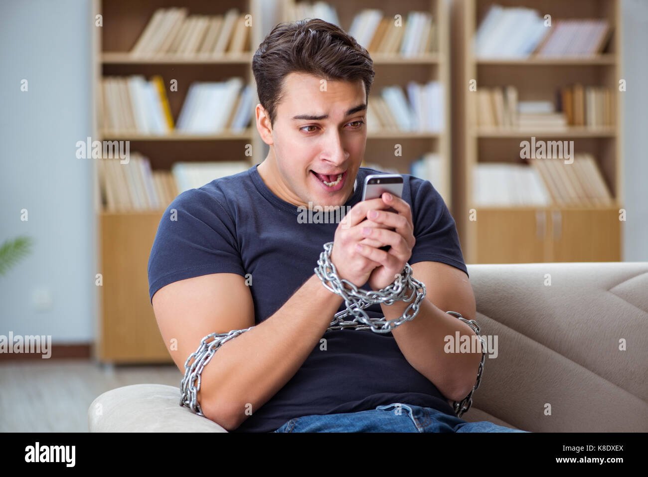 Man suffering from phone dependence addiction Stock Photo - Alamy