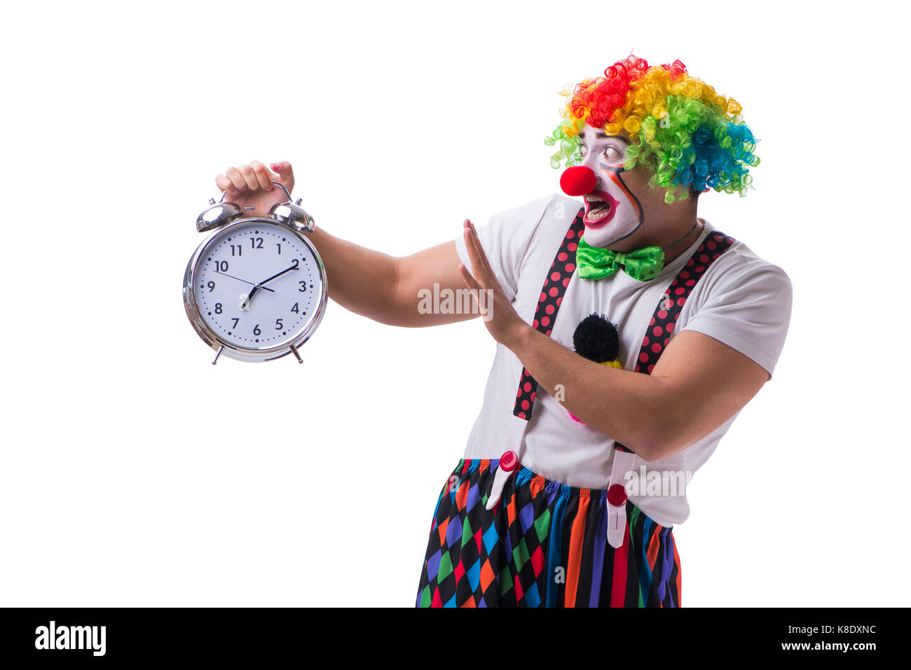 Funny clown with an alarm clock isolated on white background Stock ...
