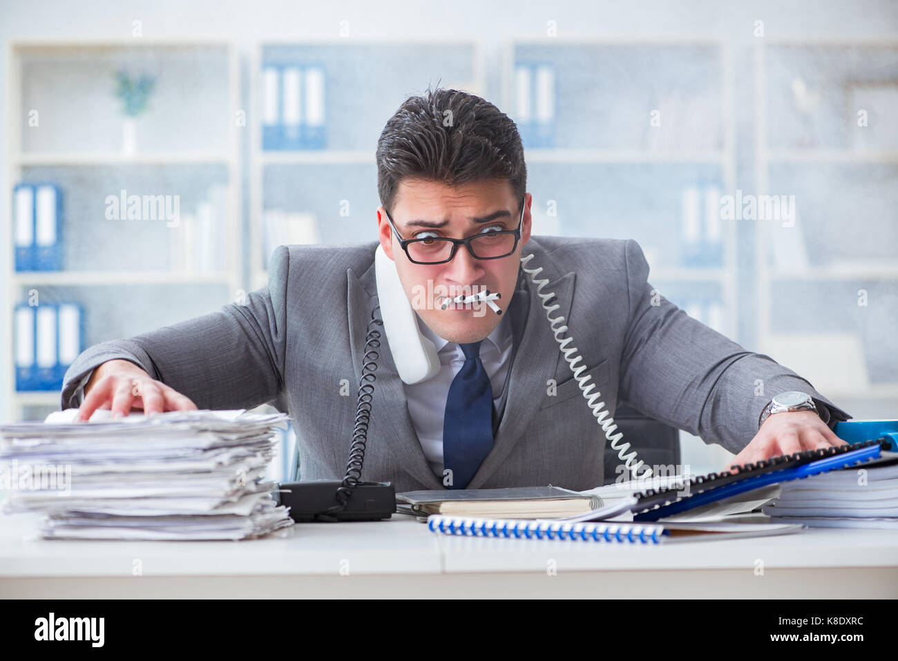 Businessman smoking in office at work Stock Photo - Alamy