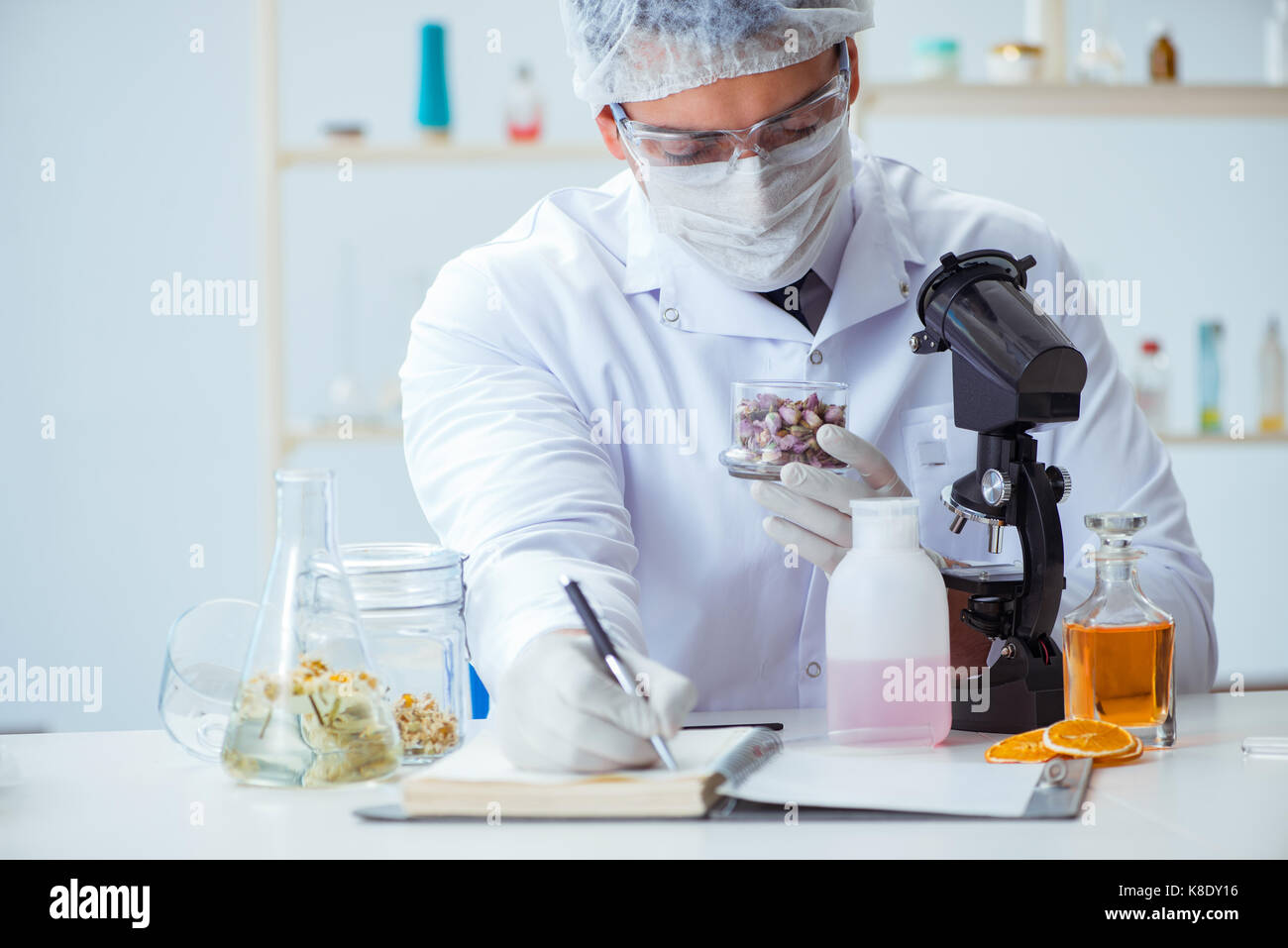Chemist mixing perfumes in the lab Stock Photo - Alamy