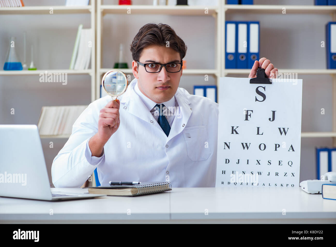 Doctor optician with letter chart conducting an eye test check Stock ...