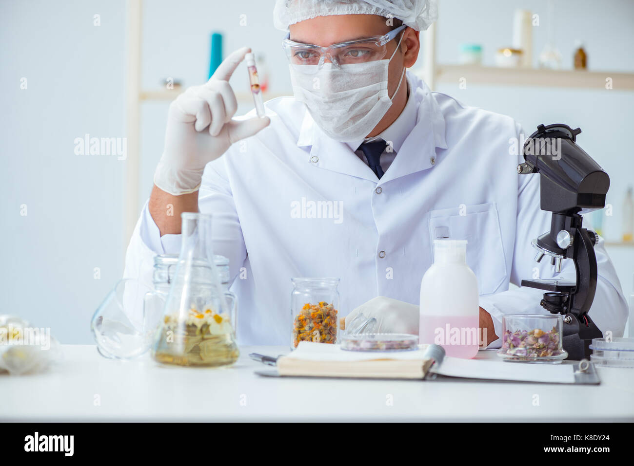 Chemist mixing perfumes in the lab Stock Photo - Alamy