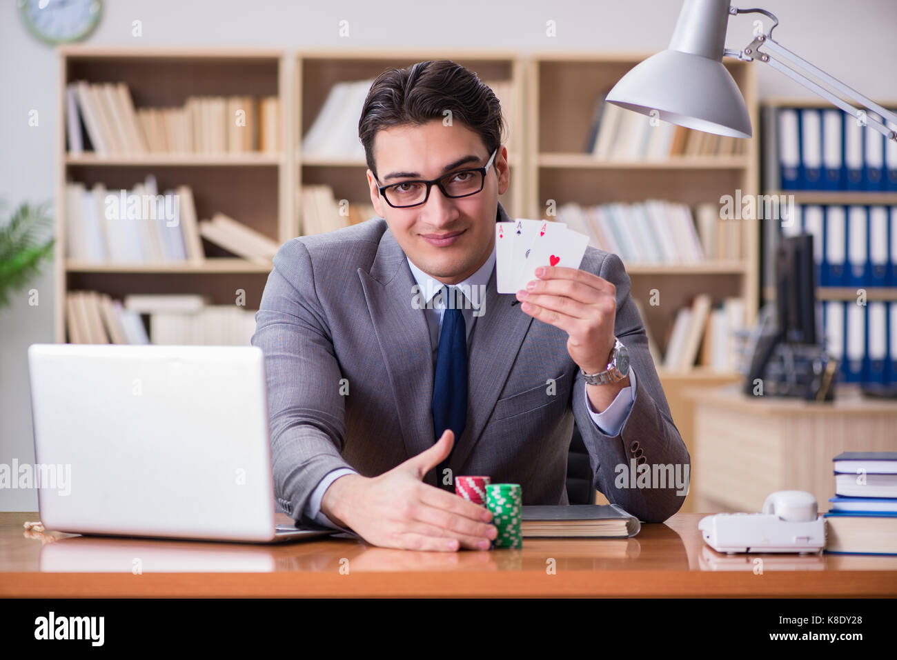 Businessman gambling playing cards at work Stock Photo - Alamy