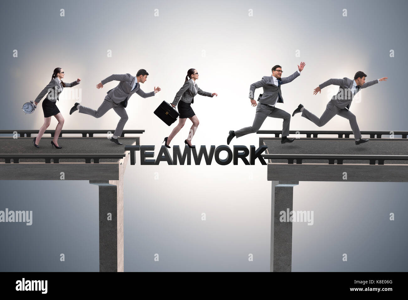 Teamwork concept with business people crossing bridge Stock Photo - Alamy