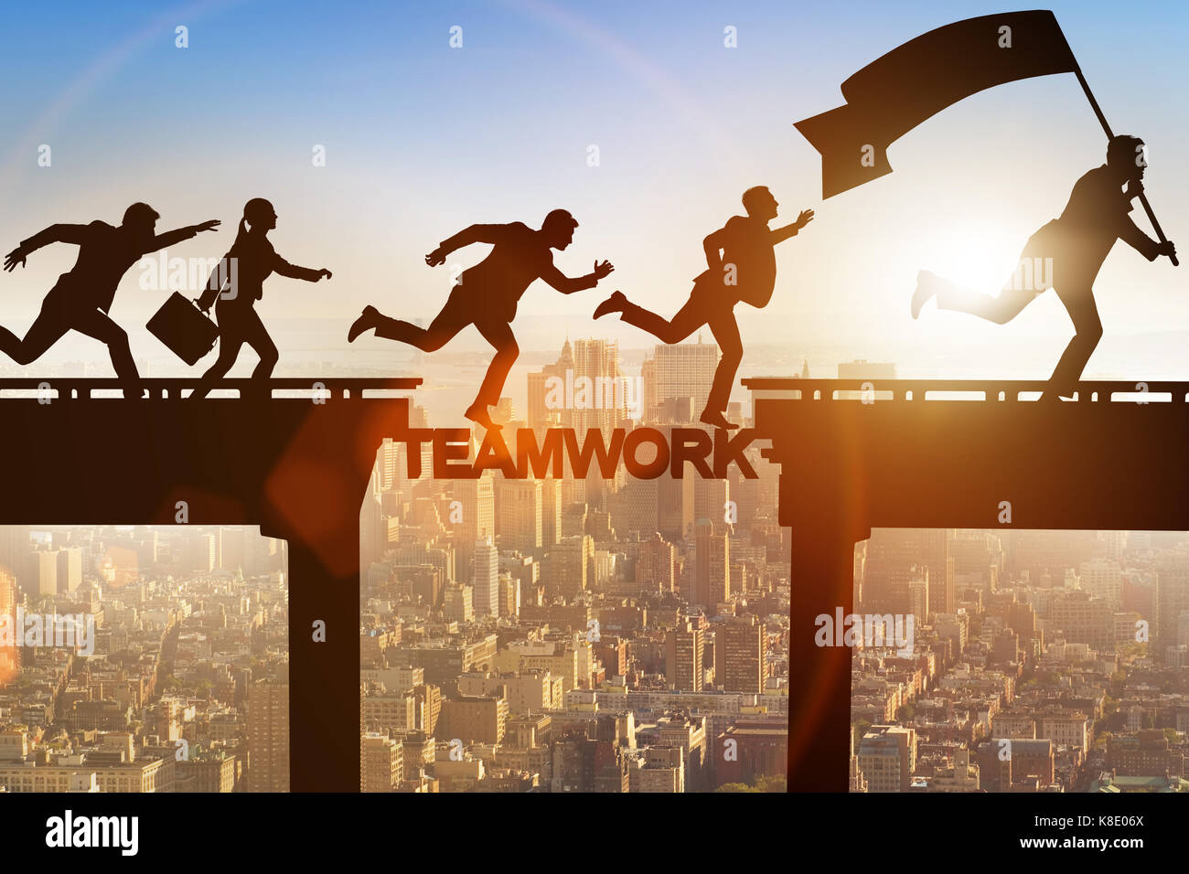 Teamwork concept with business people crossing bridge Stock Photo - Alamy