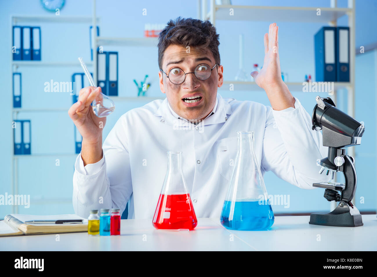 Funny mad chemist working in a laboratory Stock Photo - Alamy