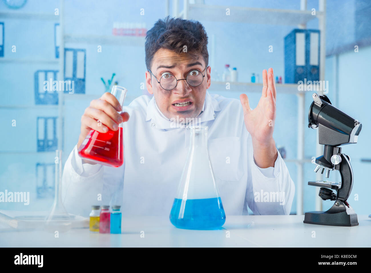 Funny mad chemist working in a laboratory Stock Photo - Alamy
