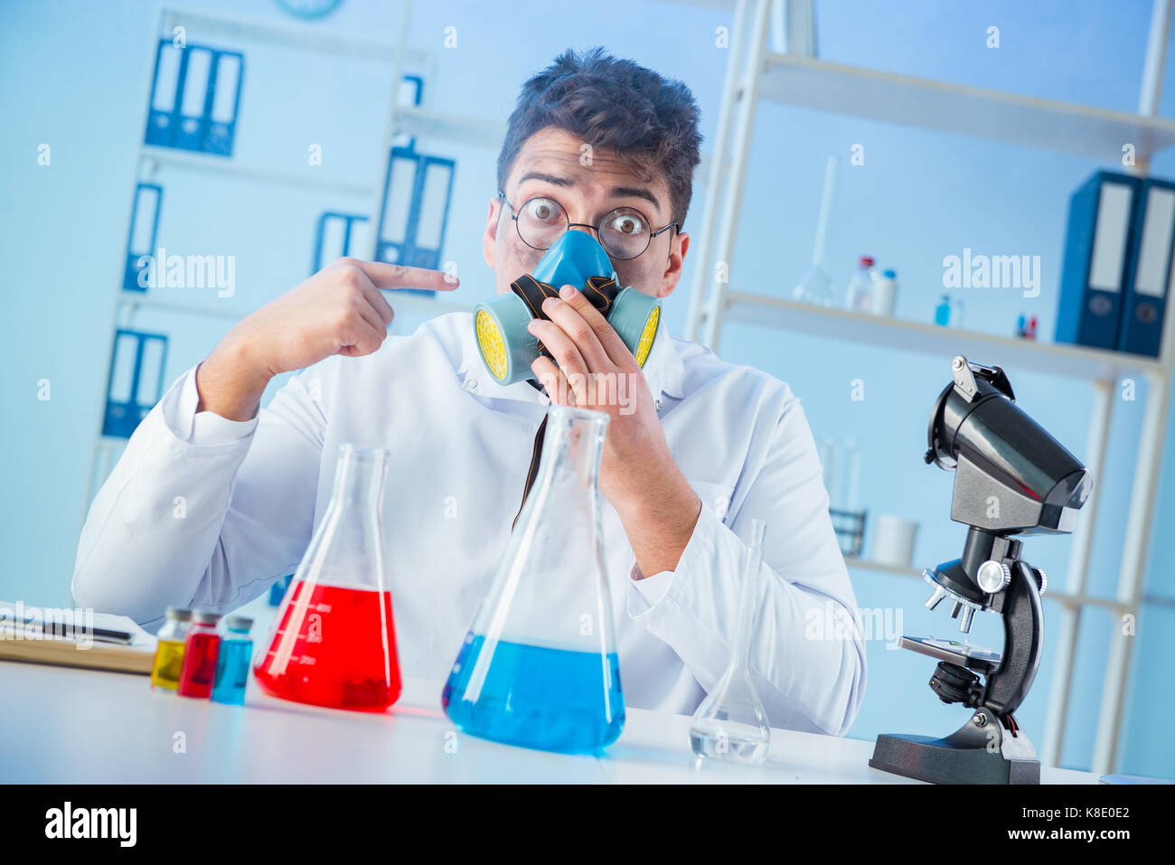 Funny mad chemist working in a laboratory Stock Photo - Alamy