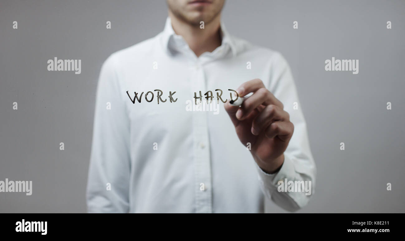 Work hard!! , Man Writing on Glass Stock Photo - Alamy