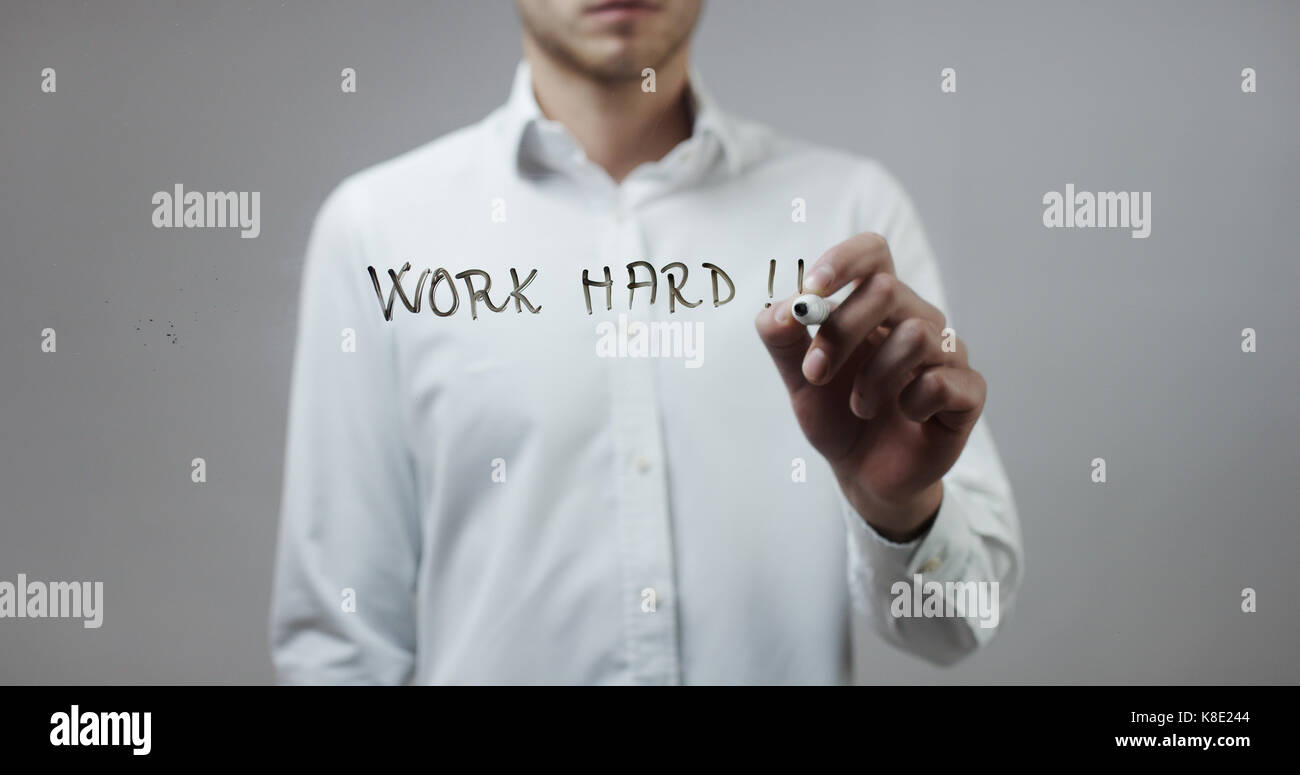 Work hard!! , Man Writing on Glass Stock Photo - Alamy
