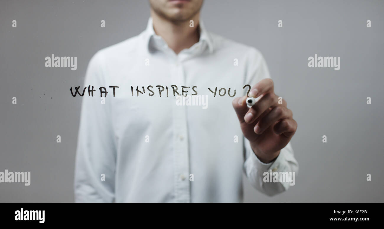 What inspires you ? , Man Writing on Glass Stock Photo - Alamy