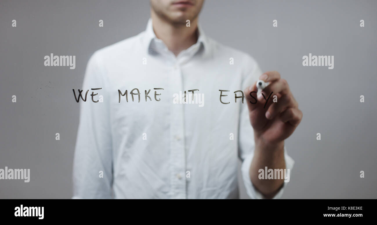 We made it easy , Man Writing on Glass Stock Photo - Alamy