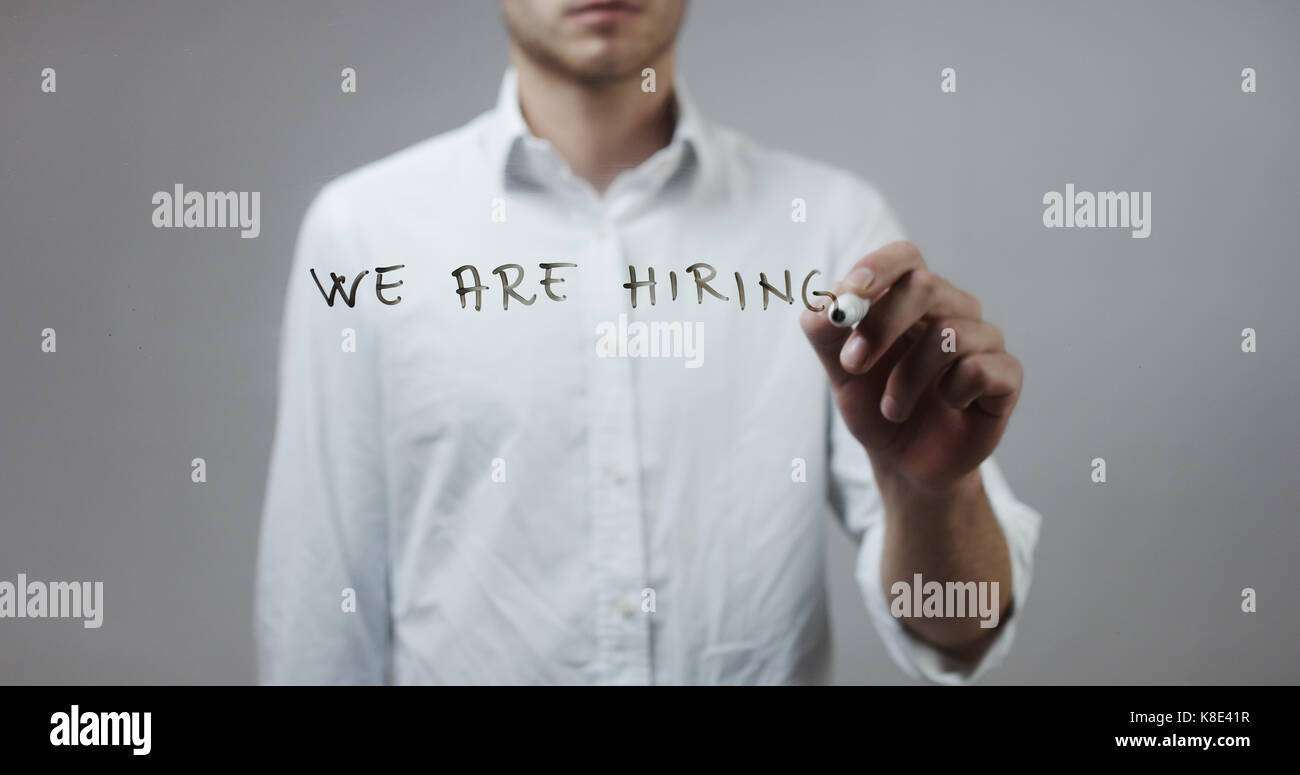 We are hiring , Man Writing on Glass Stock Photo - Alamy