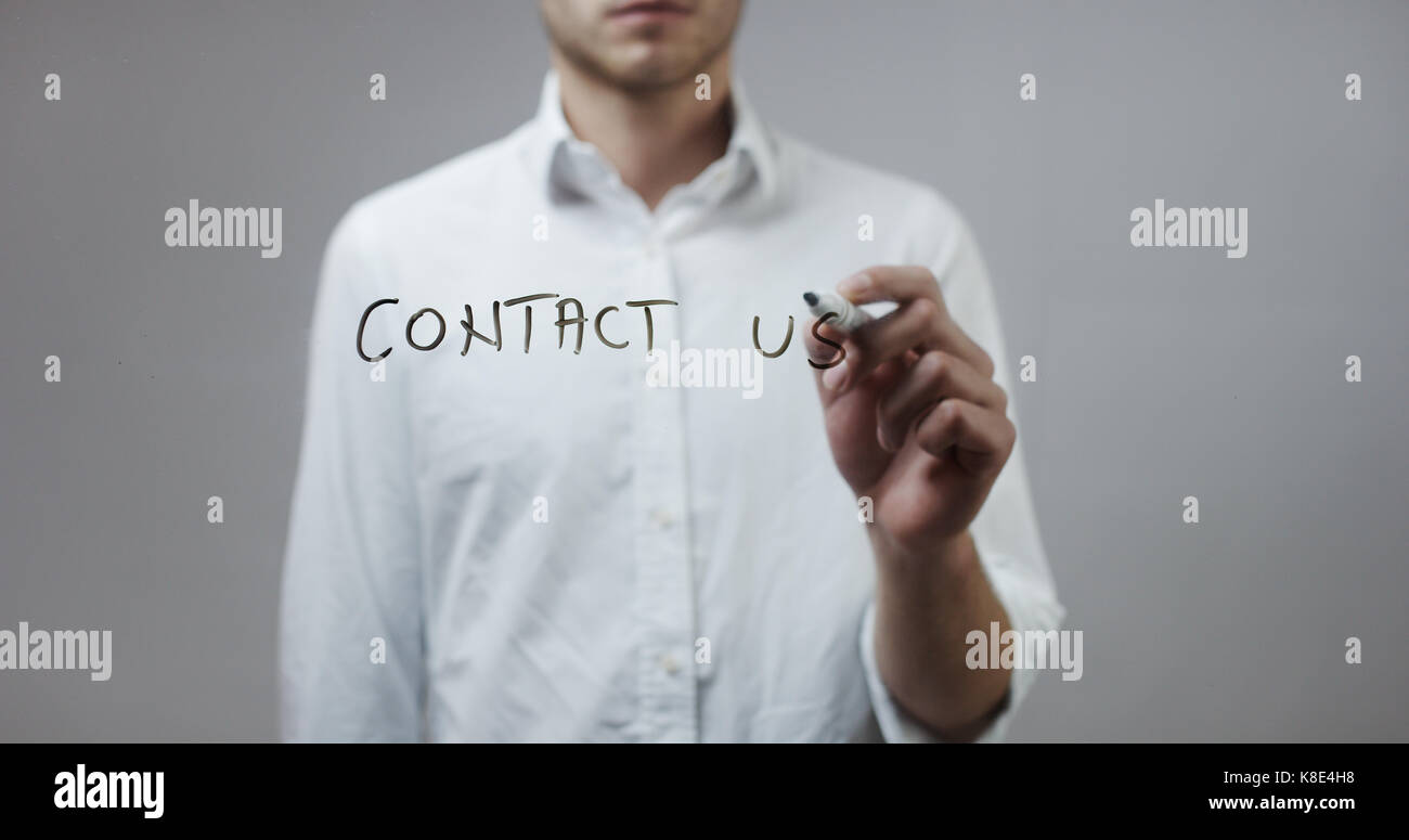 Contact us , Man Writing on Glass Stock Photo - Alamy