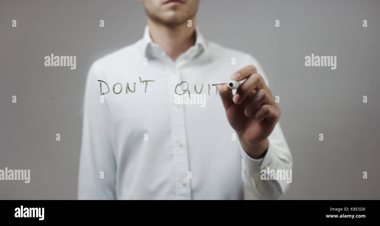 Don't quit, Man Writing on Glass Stock Photo - Alamy