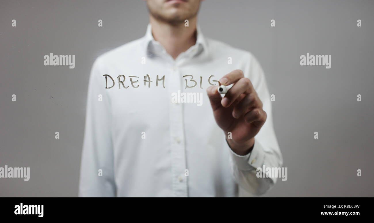 Dream big, Man Writing on Glass Stock Photo - Alamy