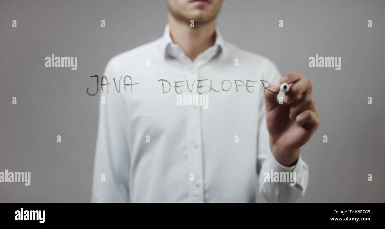 JAVA developer, Man Writing on Glass Stock Photo - Alamy
