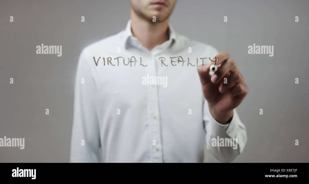 Virtual reality, Man Writing on Glass Stock Photo - Alamy