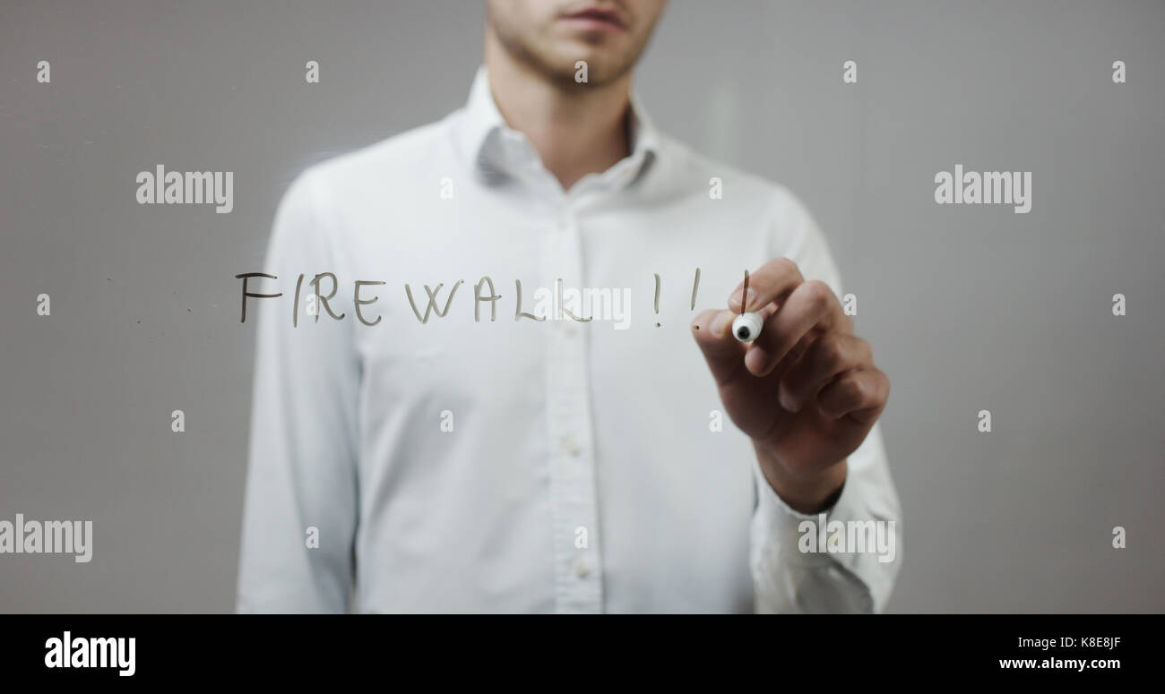 FIREWALL!!! , Man Writing on Glass Stock Photo - Alamy