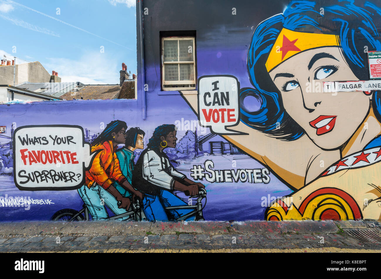 Graffiti on wall, Woman as superhero with speech bubble I can Vote ...
