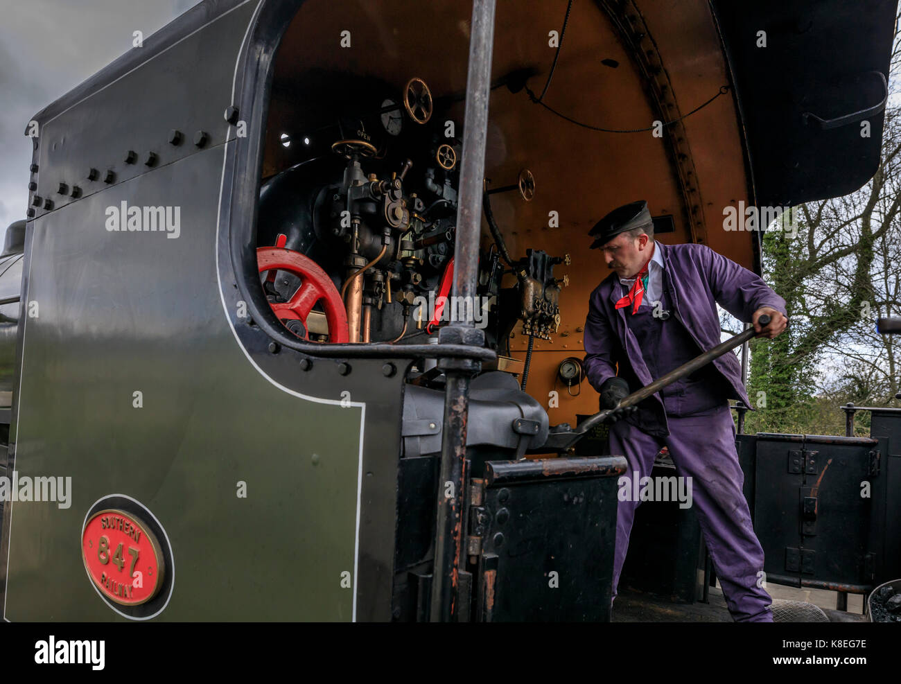 Fireman shovels coal on a steam locomotive Stock Photo - Alamy
