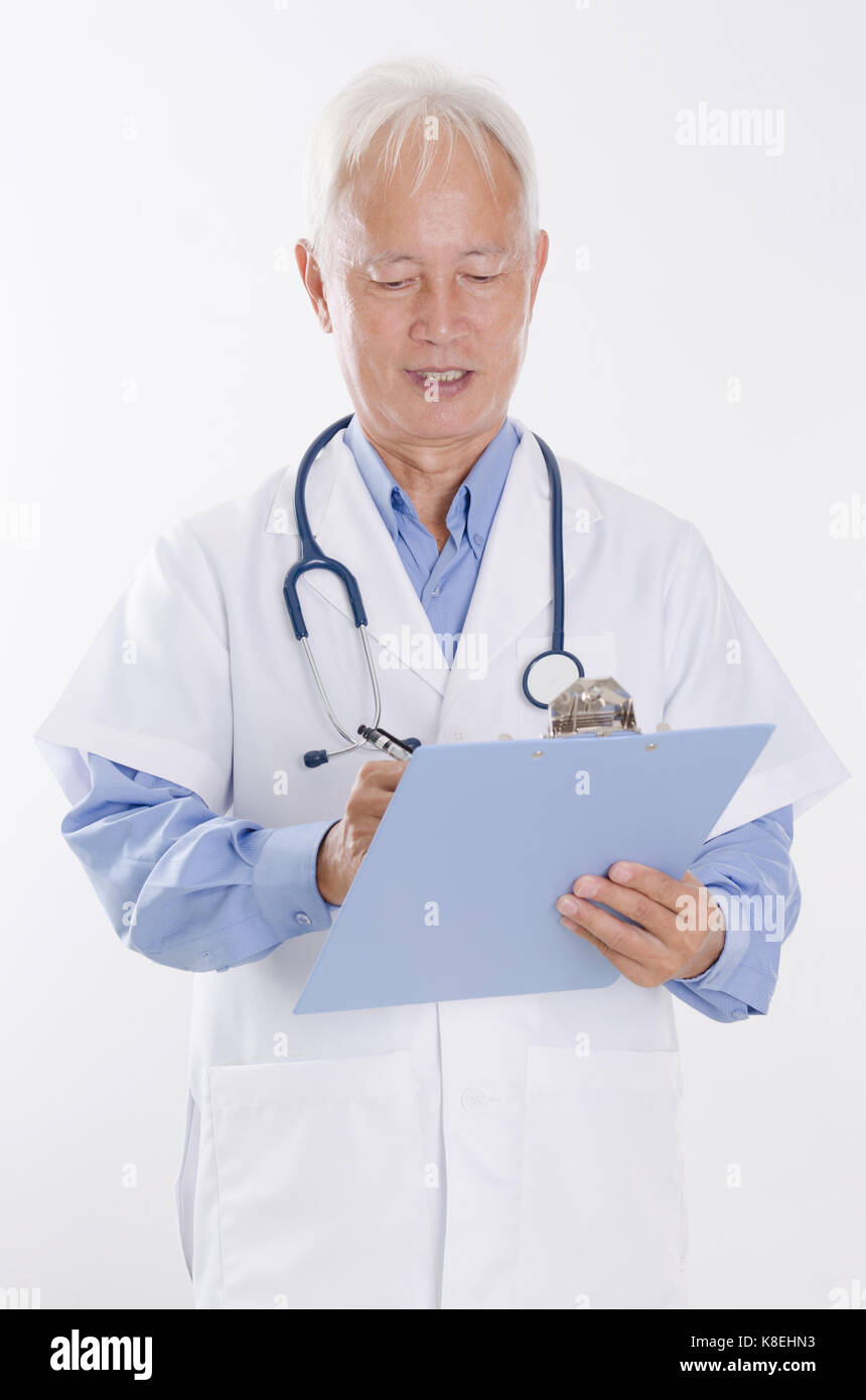 Portrait of medical doctor writing health report, standing isolated on ...