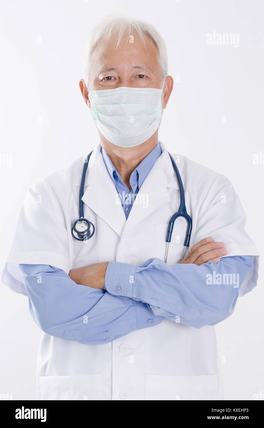 Portrait of Asian medical doctor in face mask arms crossed, standing ...