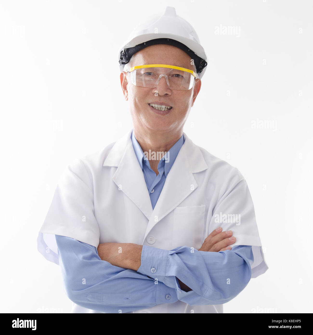 Portrait of old Asian senior engineer with hard helmet and uniform ...