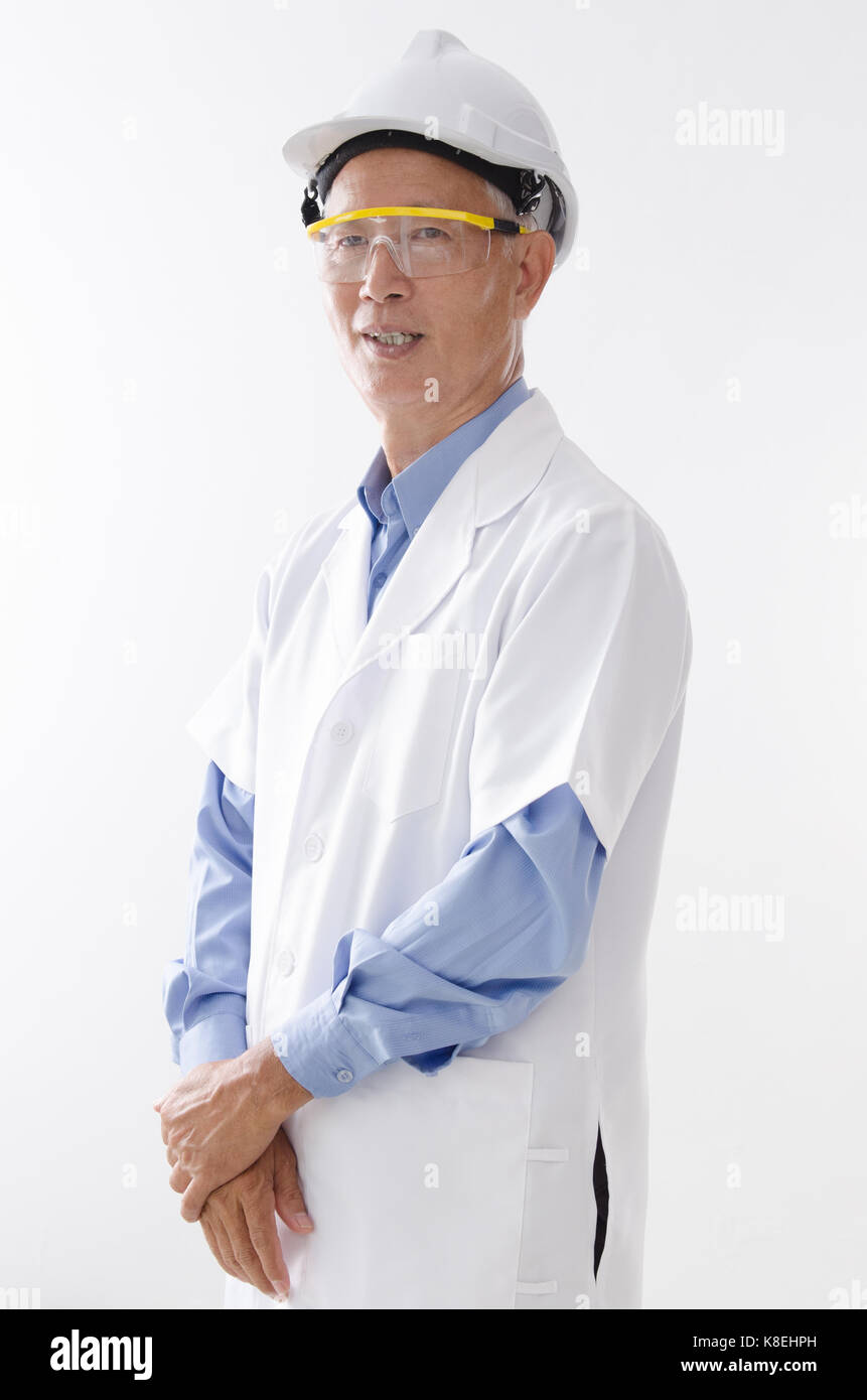 Portrait of old Asian senior engineer with hard helmet and uniform ...