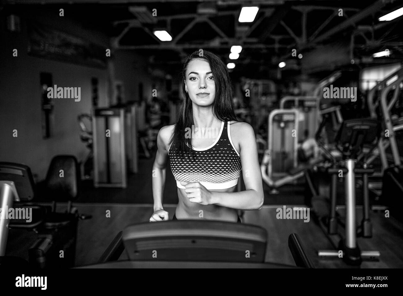 Young fitness woman doing cardio exercises at the gym running on a ...