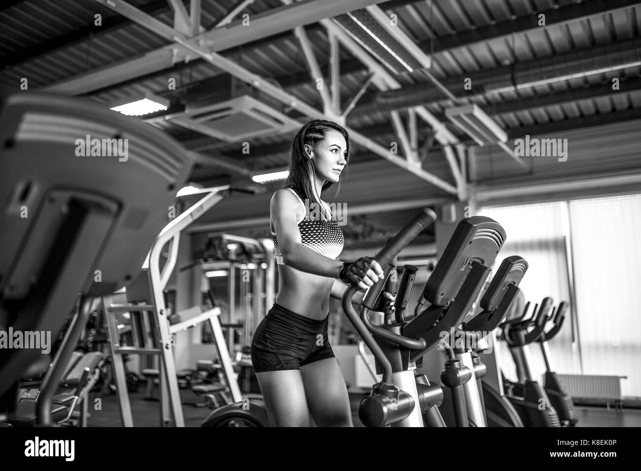 Young fitness woman doing cardio exercises at the gym running on a ...
