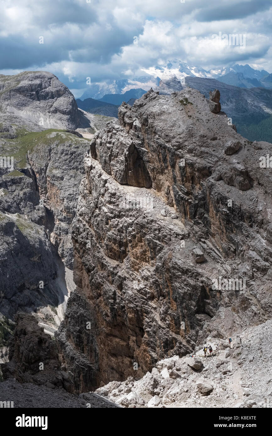 The Dolomites, Northern Italy. Hikers descending the dramatic Forcella ...