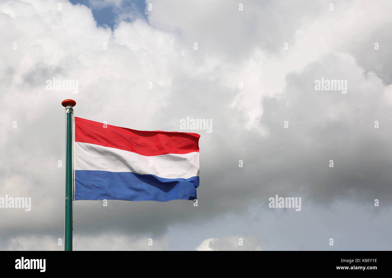 Dutch flag waving with cloudy sky background and raining Stock Photo ...