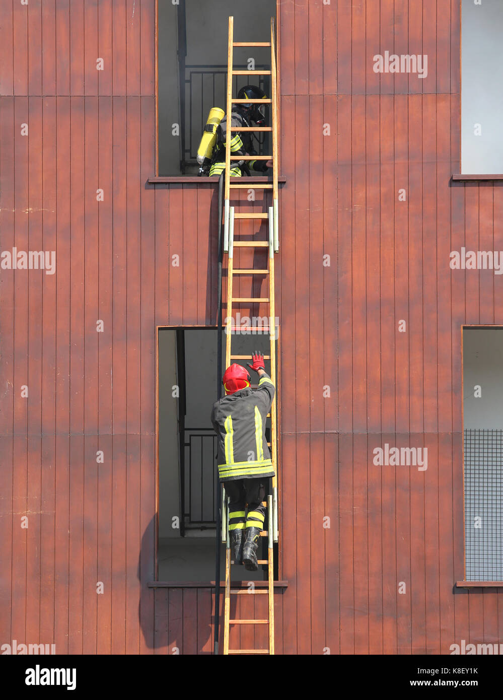 firefighters during a long ladder exercise and the fire brigade ...