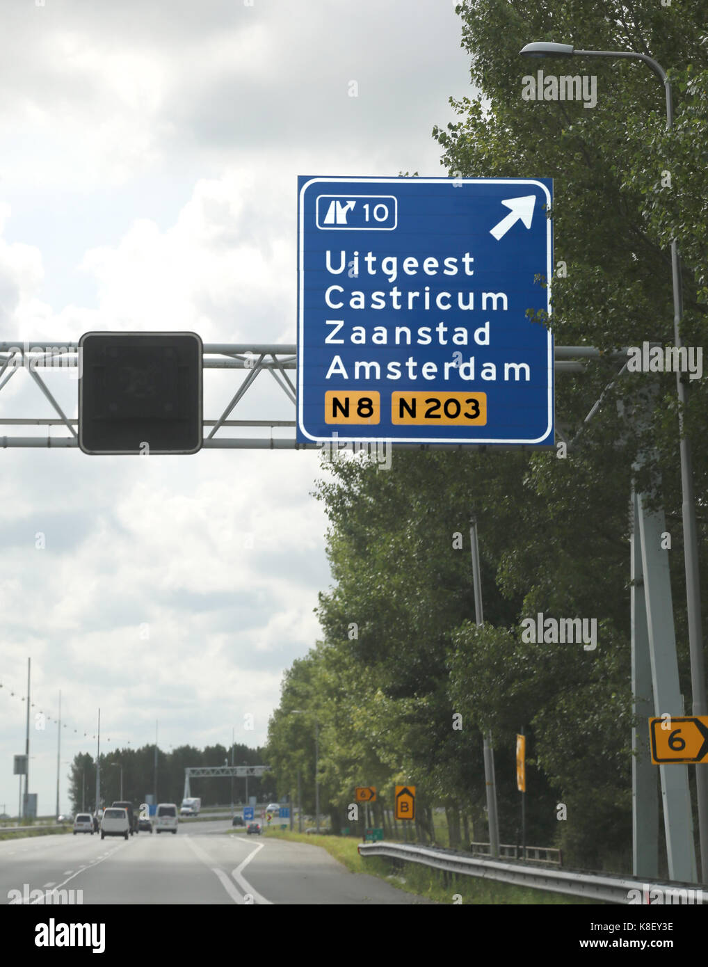 road sign on the Dutch road with directions to Amsterdam and other ...